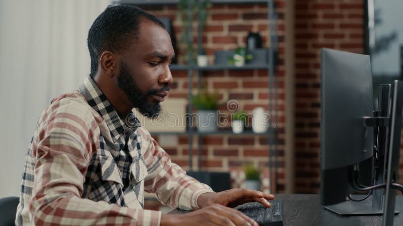 Portrait Of Programer Typing Programming Code On Computer Keyboard Turning Head And Smiling