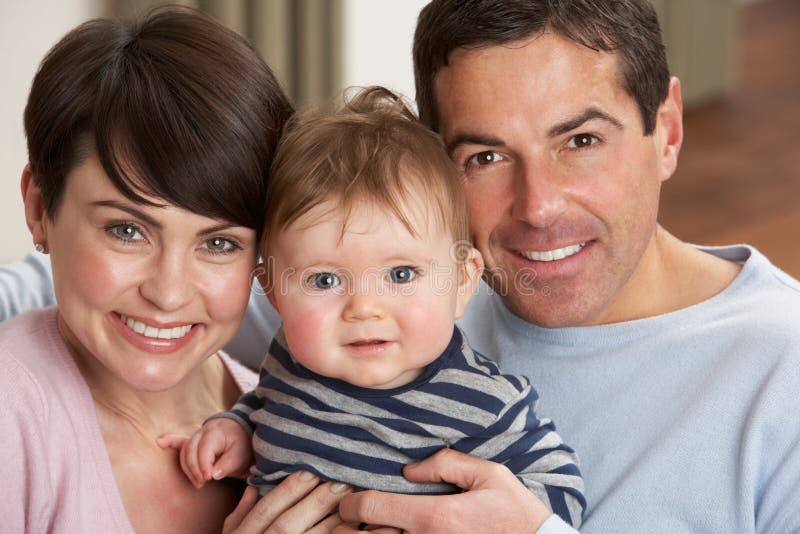 Portrait of Proud Parents with Baby Son at Home Stock Image - Image of ...