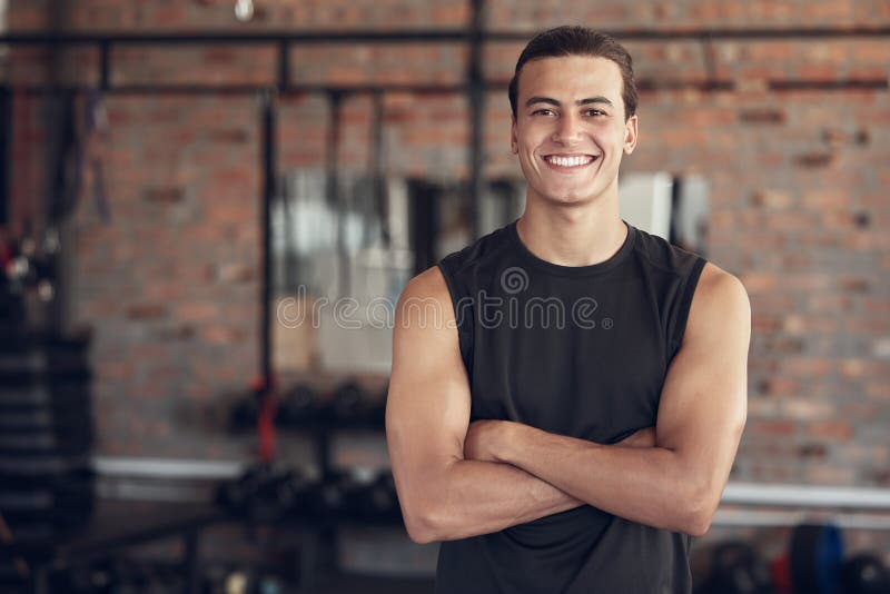 Portrait of a Proud Young Man Standing in the Gym. Happy Young Man Arms ... Portrait of a Proud Young Man Standing in the Gym. Happy Young Man Arms ...