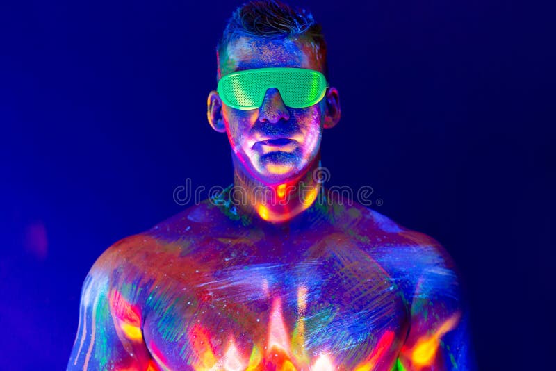 Portrait of a Pumped-up Man at a Disco. Fluorescent Paint on Face in ...