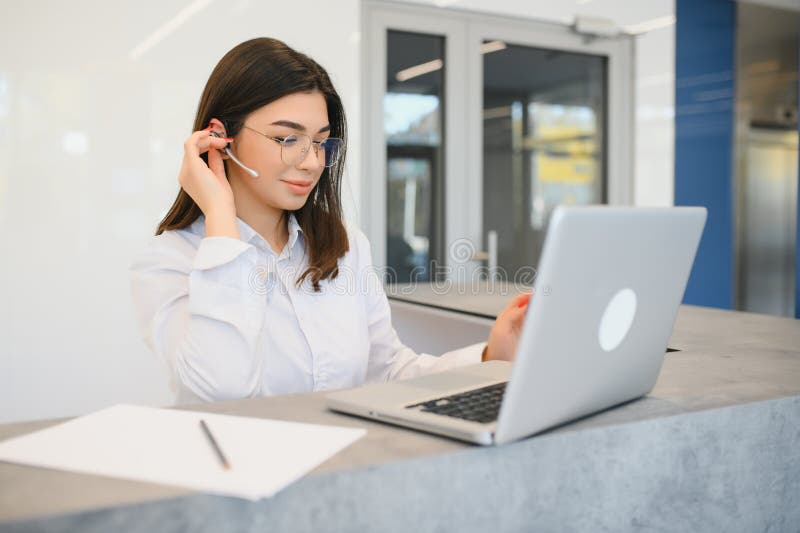 Portrait of Receptionist at Desk in Lobby Stock Image - Image of desk ...