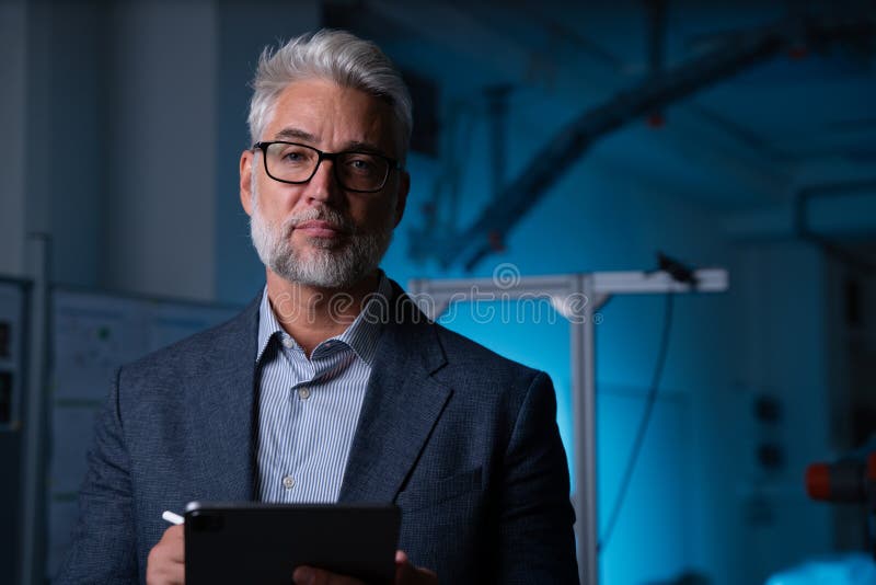 Portrait of Robotics Engineer Holding Tablet, Standing in Laboratory ...