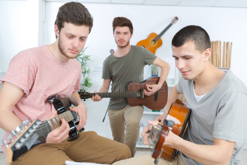 Portrait Rock Band Trio Embraced in Studio Stock Photo - Image of ...