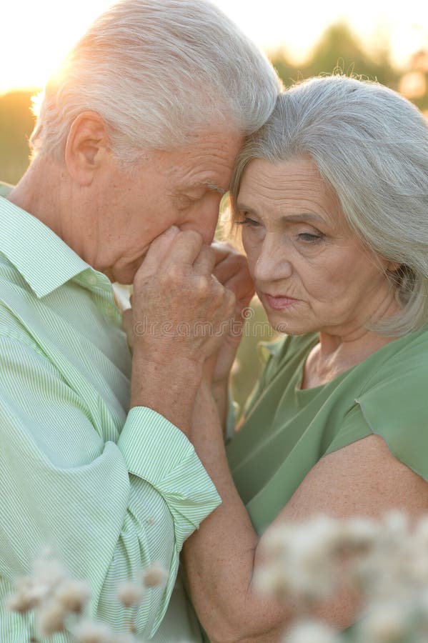Portrait of Sad Elderly Couple Standing Outdoors Stock Image - Image of ...