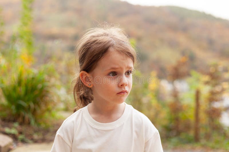 Portrait of a Sad Little Girl in the Park. Stock Image - Image of ...