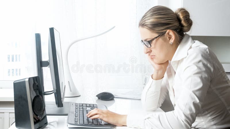 Portrait of Sad Young Businesswoman Working on Computer Stock Photo ...