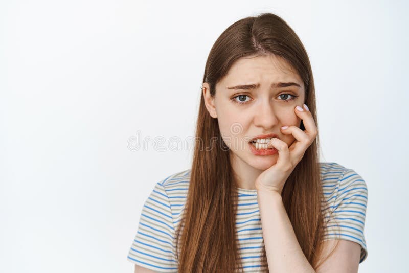 Portrait Of Scared Girl Biting Her Finger Looking Anxious And Worried