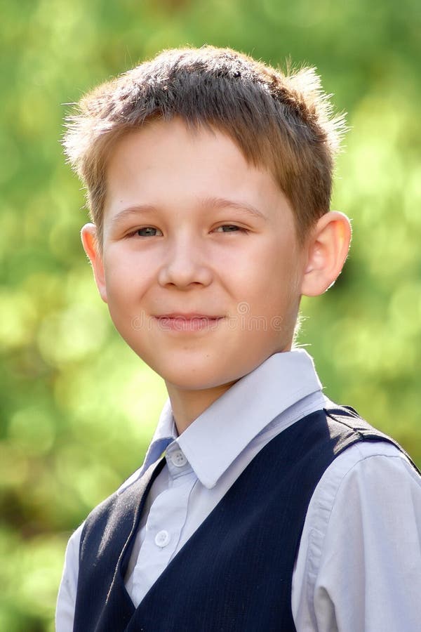 Portrait of a Schoolboy Looking into the Camera on a Blurry Background ...
