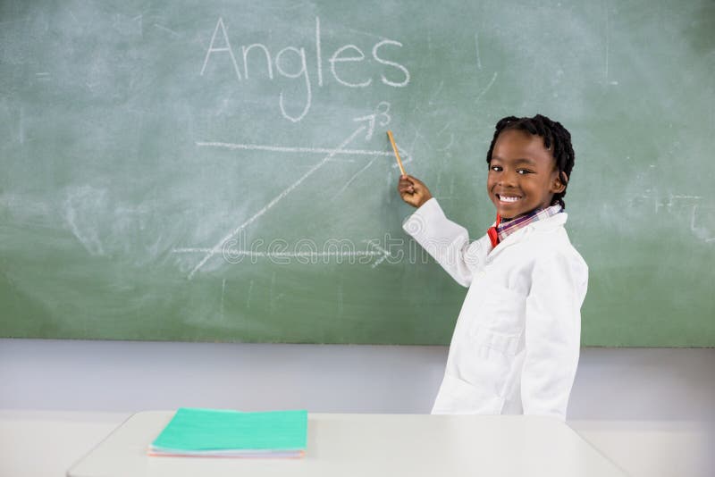 Portrait of Schoolboy Showing Mathematics on Chalkboard in Classroom ...