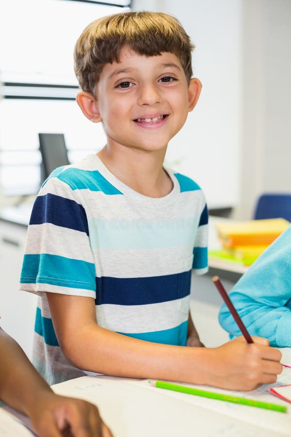 Portrait of Schoolboy Smiling in Classroom Stock Image - Image of ...
