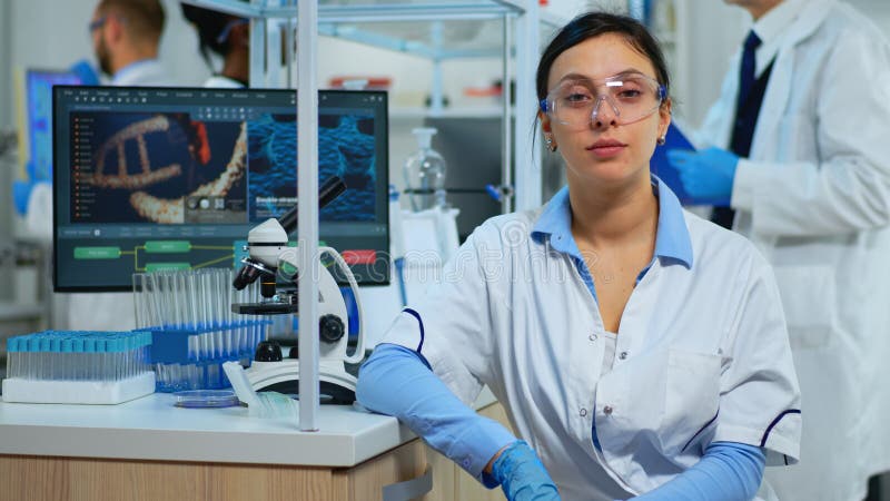 Portrait of Scientist Smiling at Camera Sitting in Modern Laboratory ...
