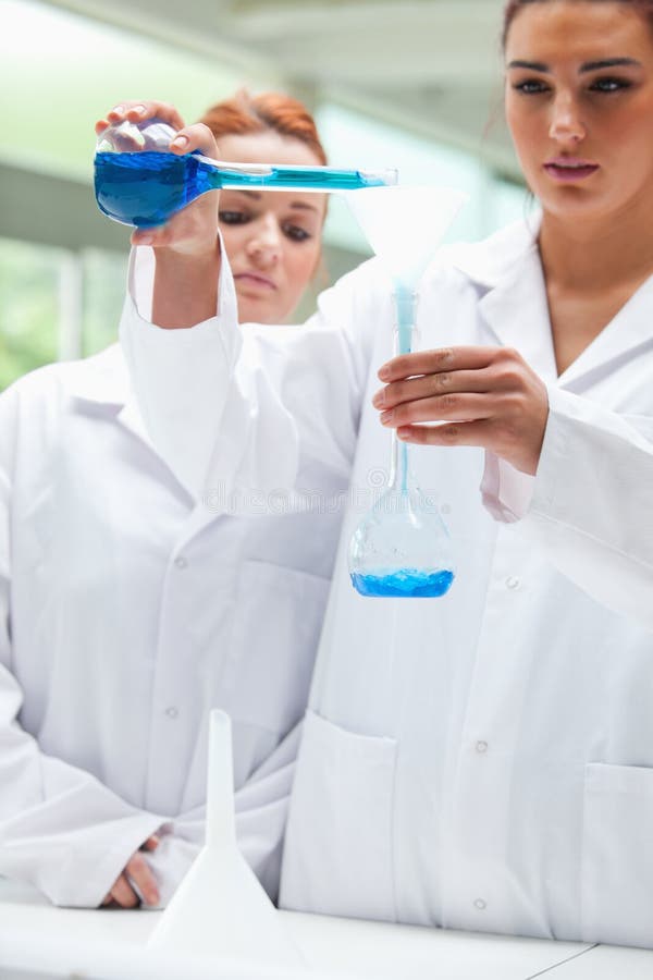 Portrait of Scientists Pouring Liquid into a Flask Stock Photo - Image ...