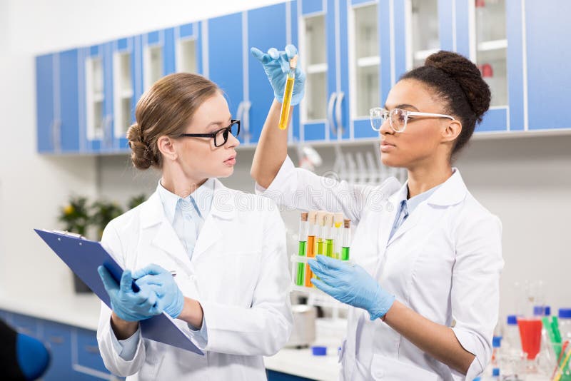 Portrait Of Scientists In Lab Coats And Eyeglasses Looking At Flask ...