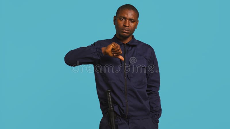 Portrait of Security Agent Doing Thumbs Down Sign Gesturing, Refusing ...