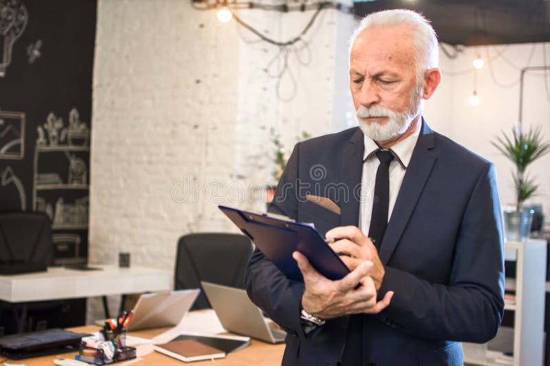 Portrait of Senior Businessman in Formal Suit Checking Paper Documents ...