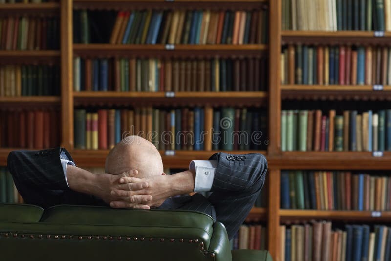 Portrait of Senior Businessman Sitting in Library Stock Image - Image ...