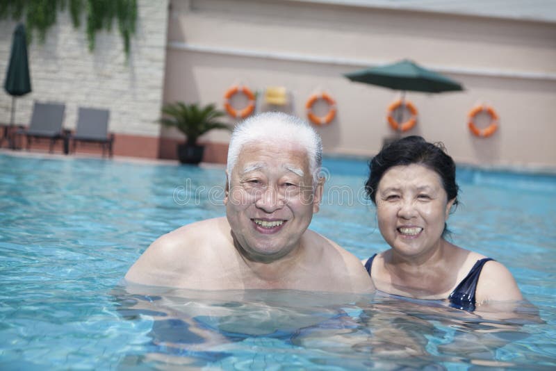 Portrait of Senior Couple Relaxing in the Pool Stock Image - Image of ...