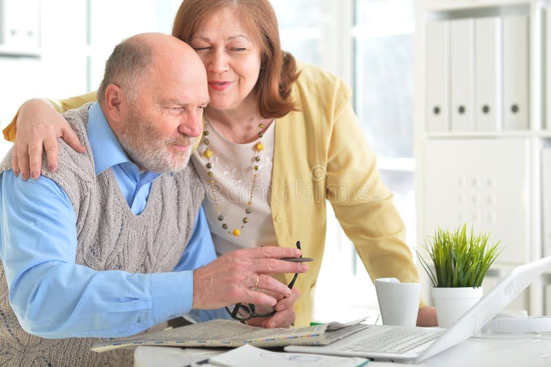 Portrait of Senior Couple Using Laptop in the Office Stock Photo ...