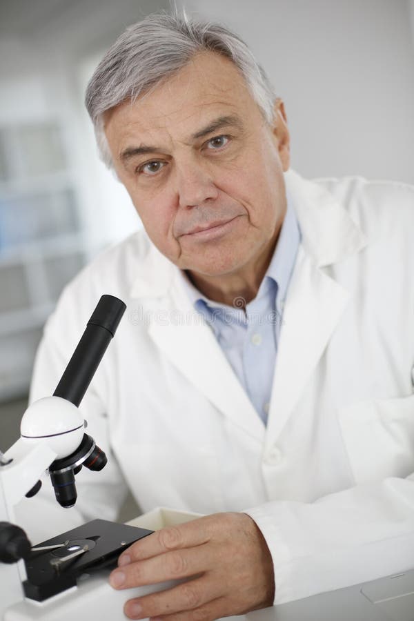 Portrait of Senior Doctor Looking through Microscope Stock Image ...
