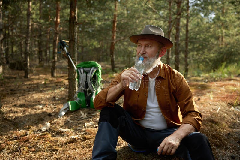 Portrait of Senior Elderly Man Drinking Water while Rest in Forest ...