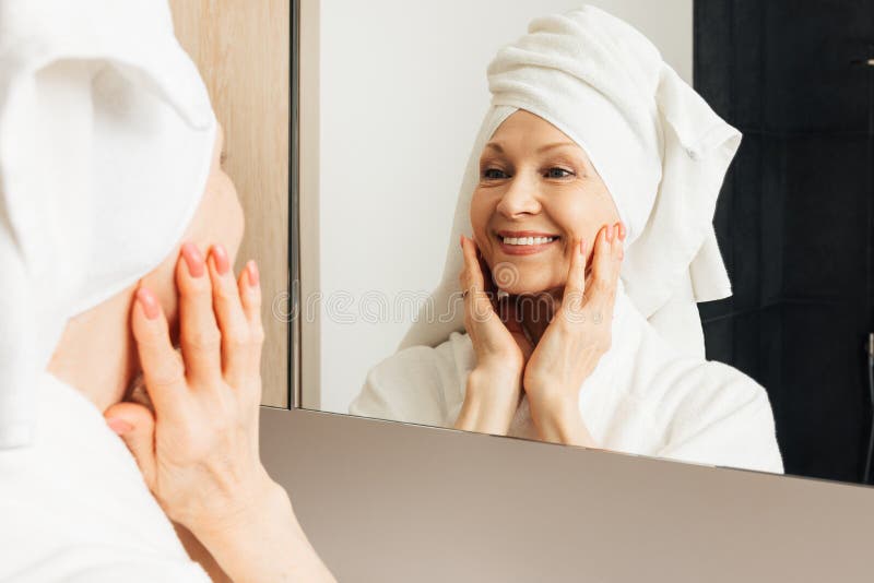 Portrait Of A Senior Female With A Towel On Her Head Aged Woman