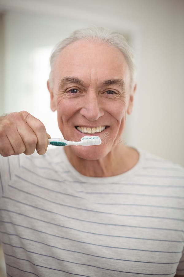 Man Holding Toothbrush with Toothpaste in Bathroom Stock Photo - Image ...