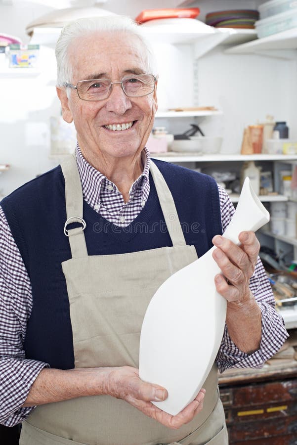 Portrait of Senior Man Holding Vase in Pottery Studio Stock Photo ...