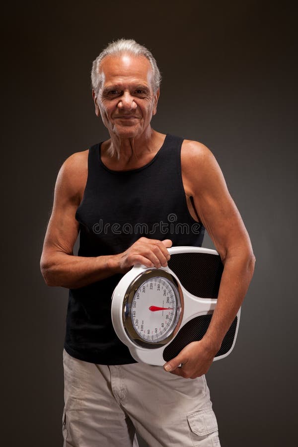 Portrait of a Senior Man Posing with a Weighing Scale Stock Photo ...