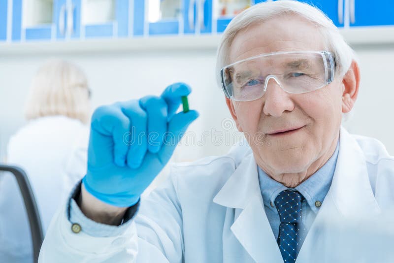 Portrait of Senior Man Scientist Showing Pill in Hand Stock Photo ...