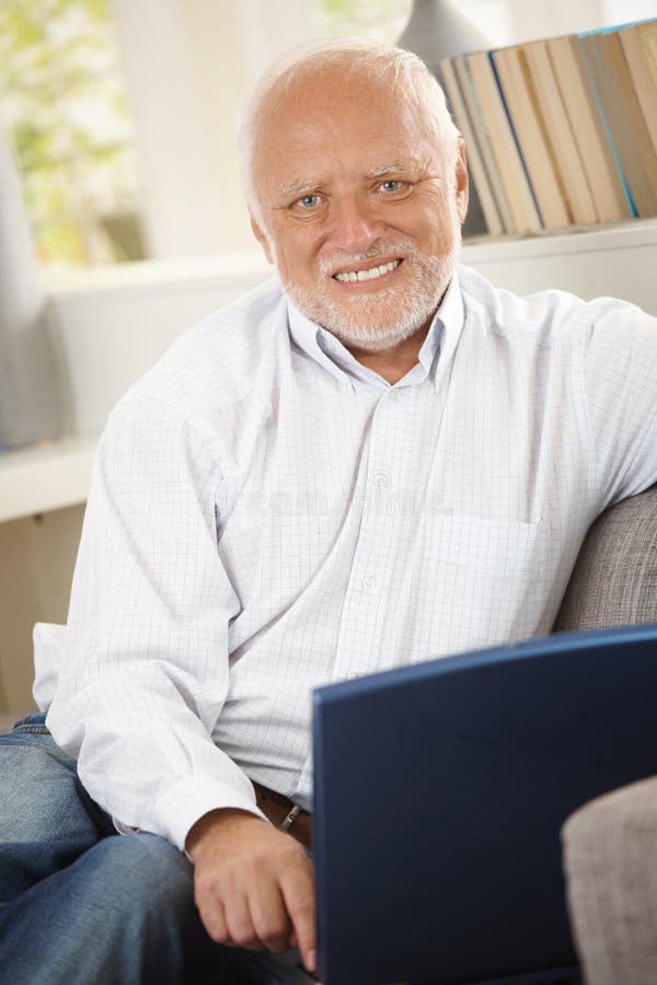 Portrait of Senior Man Using Computer on Sofa Stock Image - Image of ...