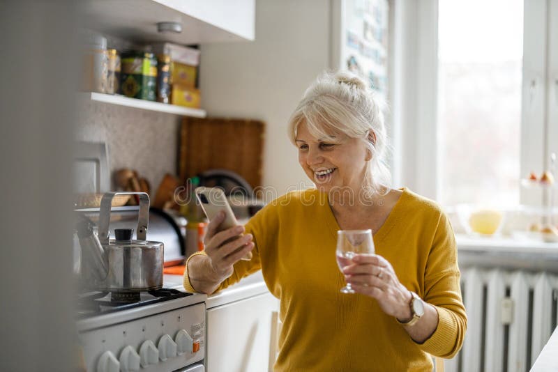 Senior Woman Using Mobile Phone at Home Stock Image - Image of female ...