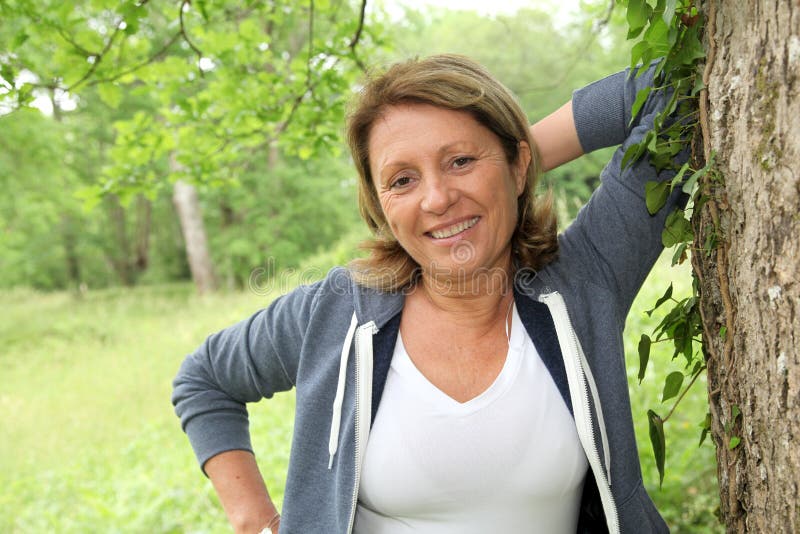 Portrait of Senior Woman Leaning on Tree Stock Image - Image of leisure ...