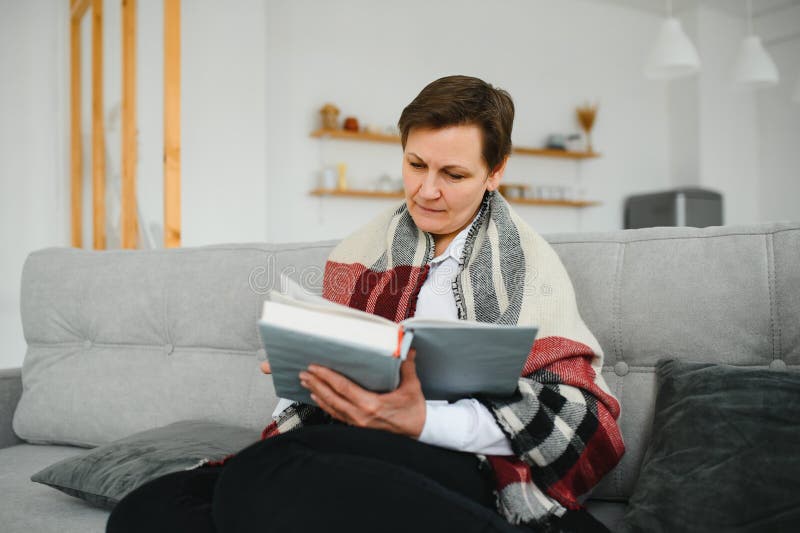 Portrait of Senior Woman Reading Book Stock Image - Image of couch ...