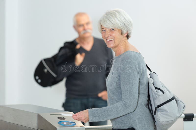 Portrait Senior Woman with Ticket at Turnstile Stock Photo - Image of ...