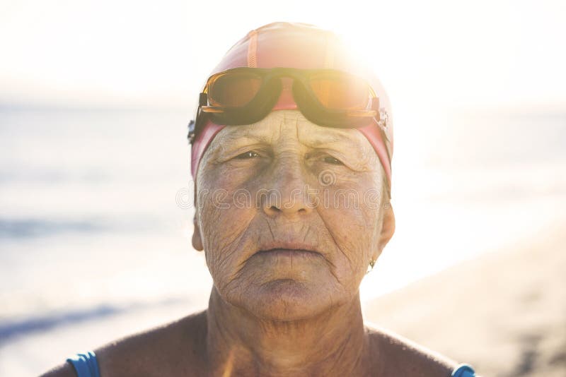Portrait Of A Senior Woman Wearing A Blue Swimsuit And Swimming Goggles
