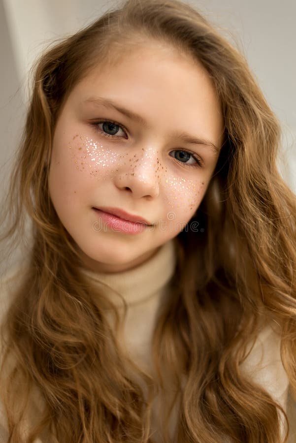 Portrait Of Serious Girl With Golden Star Freckles And Long Hair