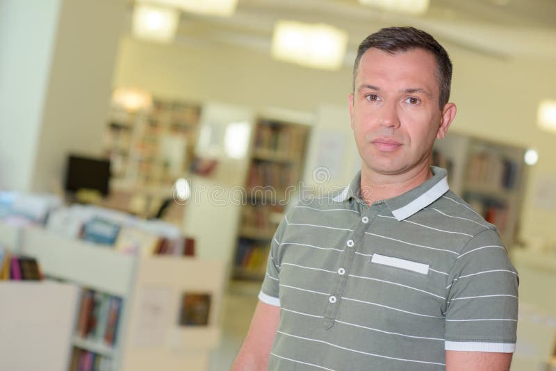 Portrait Serious Man in Library Stock Image - Image of stand, strn ...