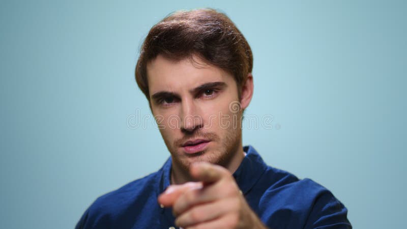 Serious Man Pointing Finger on Blue Background. Confident Guy Posing in ...