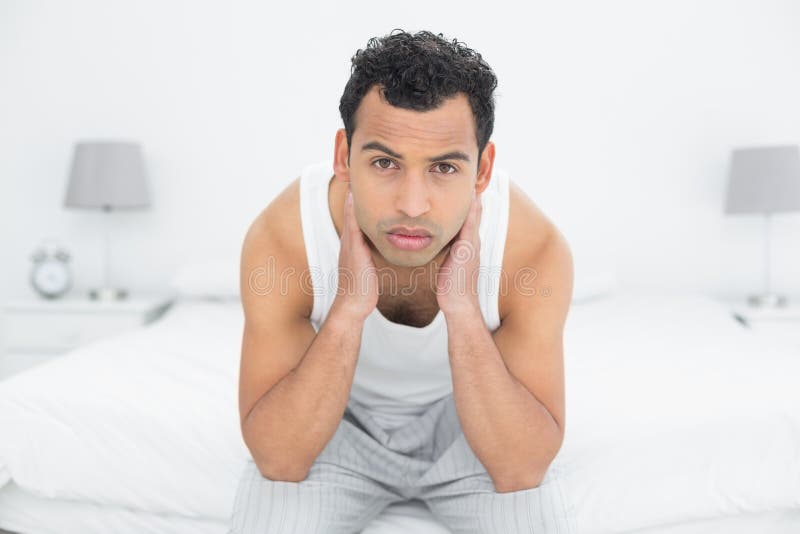Portrait of a Serious Man Sitting on Bed Stock Image - Image of view ...