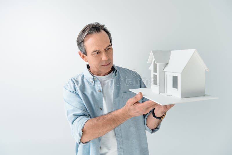 Portrait of Serious Mature Man Holding House Model Stock Image - Image ...