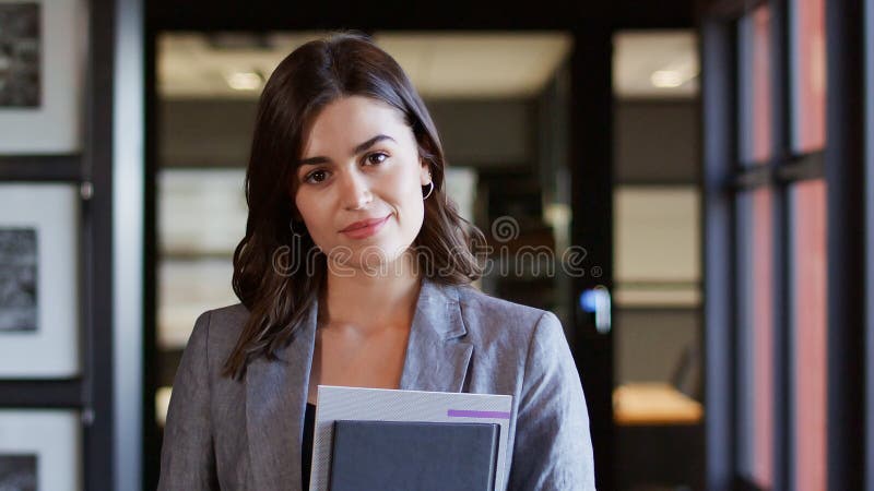Portrait of Serious Young Businesswoman Holding Documents Working in ...