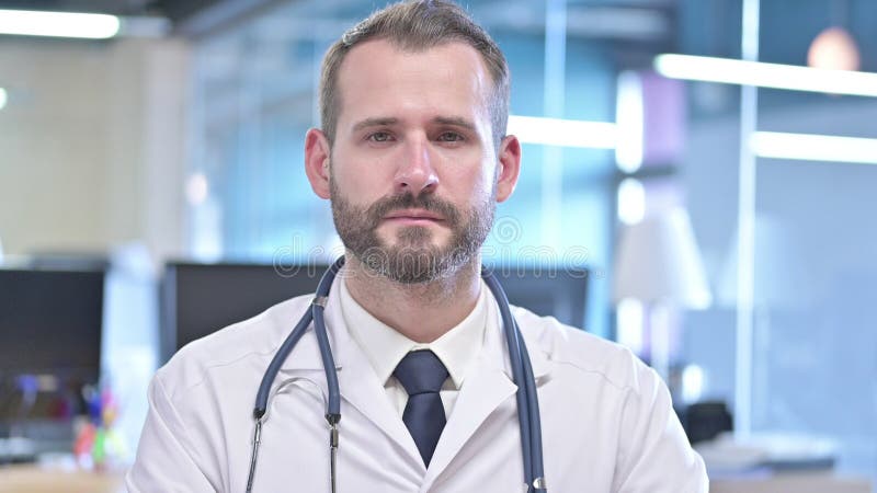 The Portrait of Serious Young Doctor Looking at Camera Stock Image ...
