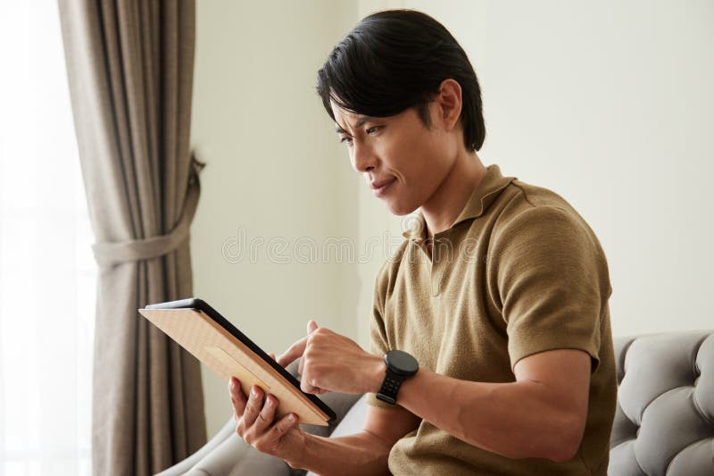 Man Reading Article on Tablet Stock Photo - Image of correct, nomad ...