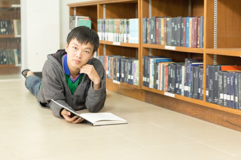Portrait of a Serious Young Student Reading a Book in a Library Stock ...