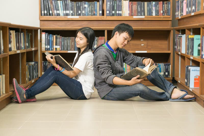 Portrait of a Serious Young Student Reading a Book in a Library Stock ...