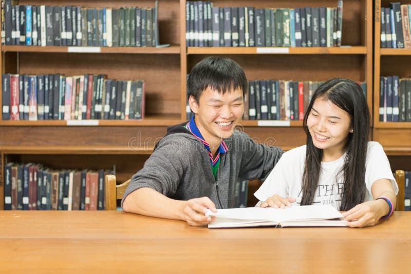 Portrait Of A Serious Young Student Reading A Book In A Library Stock ...
