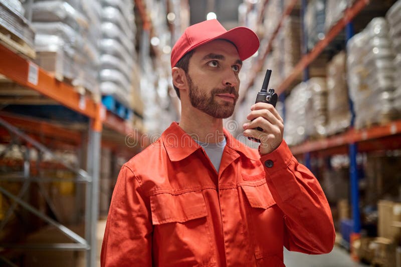 Man with a Handheld Transceiver Standing in the Warehouse Stock Image ...