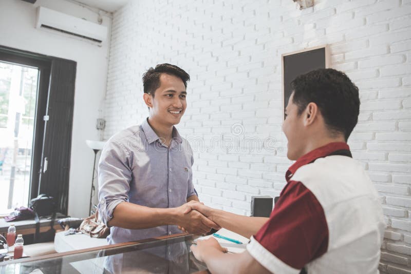 Shop Owner Shaking Hand of His Client Stock Photo - Image of deal ...