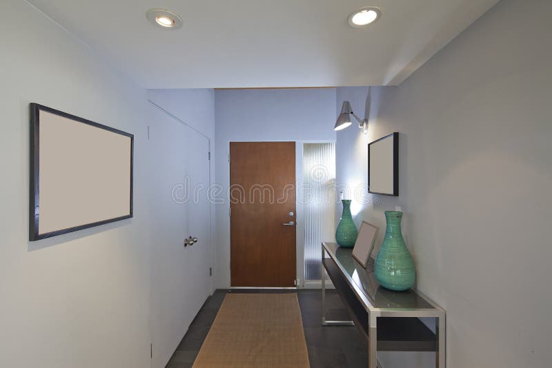 Entry with Paintings and Side Table Stock Photo - Image of house ...