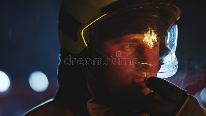 Portrait Shot of a Fireman in Action. Fire Reflection on the Helmet ...